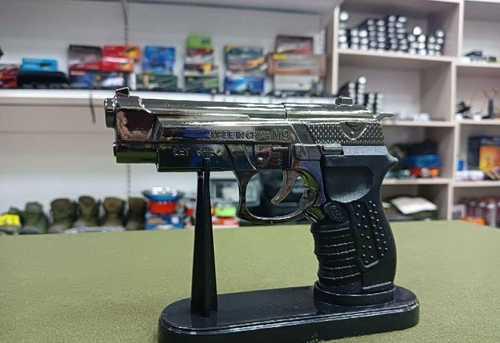 Зажигалка в виде пистолета с лазером на подставке