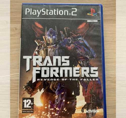 Диски на ps2 Transformers revenge of the fallen